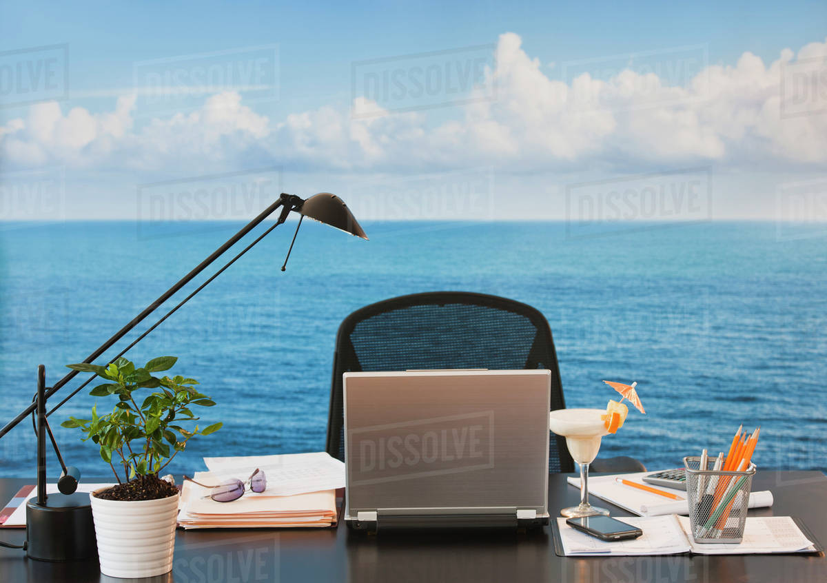 Close up of office desk with sea and sky in backgrounds - Stock Photo ...