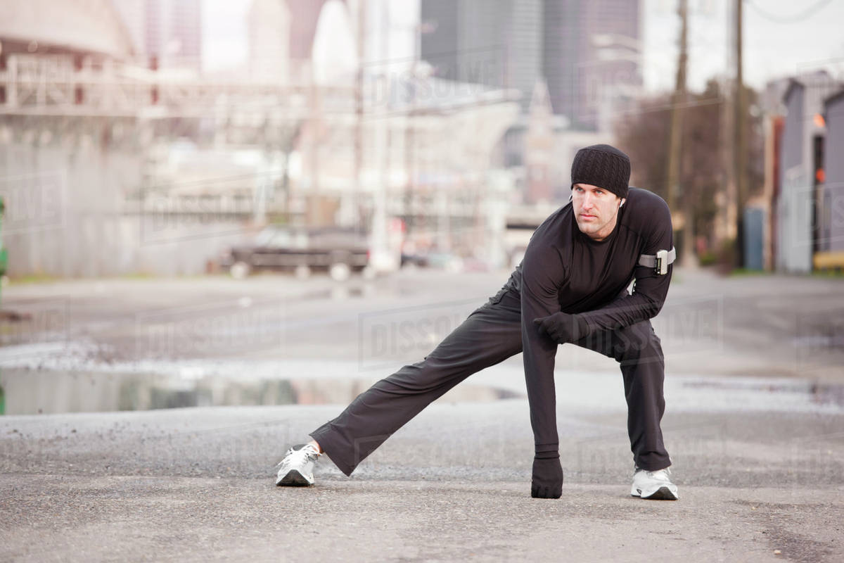 USA, Washington, Seattle, man stretching in street - Royalty-free Stock ...