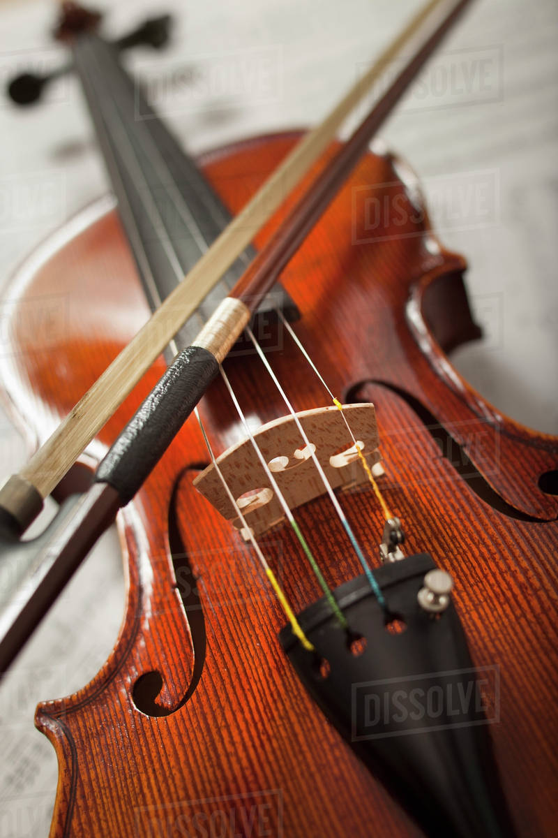 Close-up of violin on sheet music - Royalty-free Stock Photo | Dissolve
