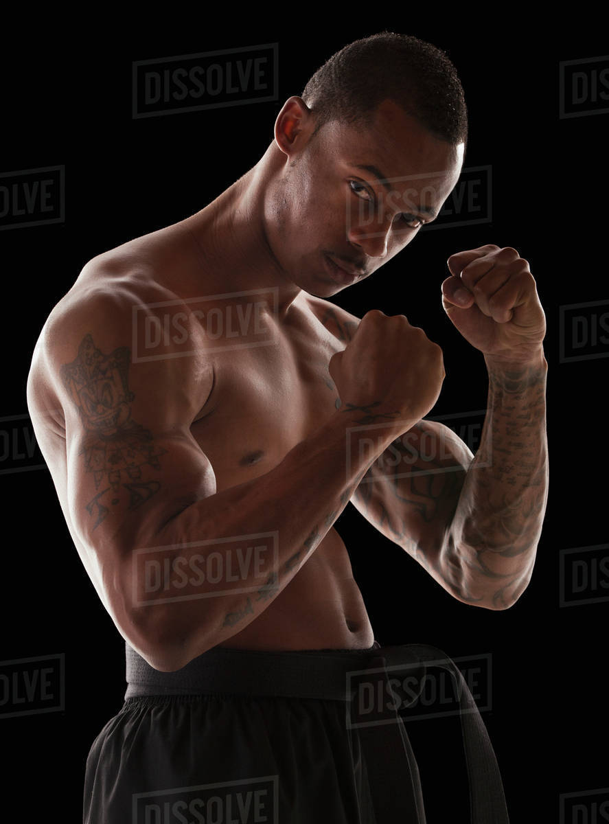 Studio portrait of muscular man in fighting stance - Royalty-free Stock ...