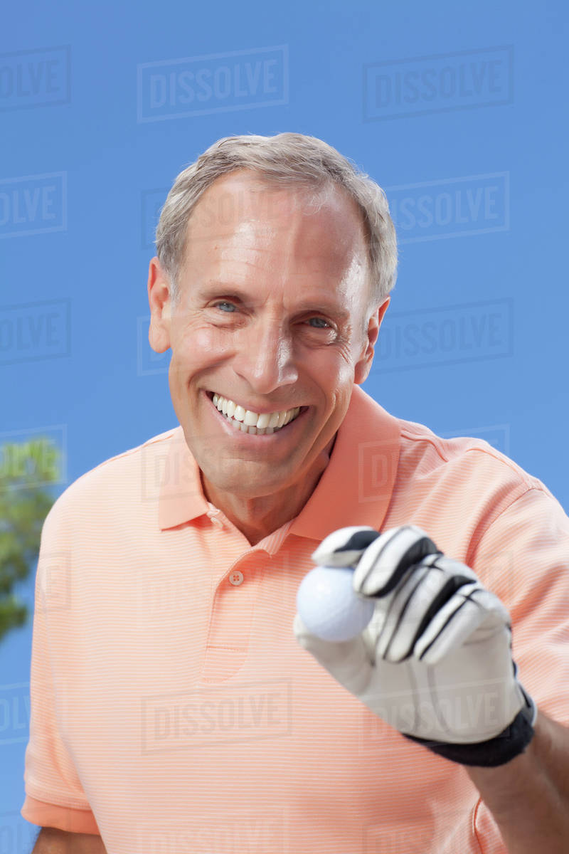 Portrait of senior man holding golf ball - Royalty-free Stock Photo ...