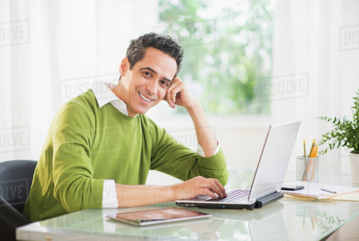 Portrait of man working on laptop at home - Royalty-free Stock Photo ...