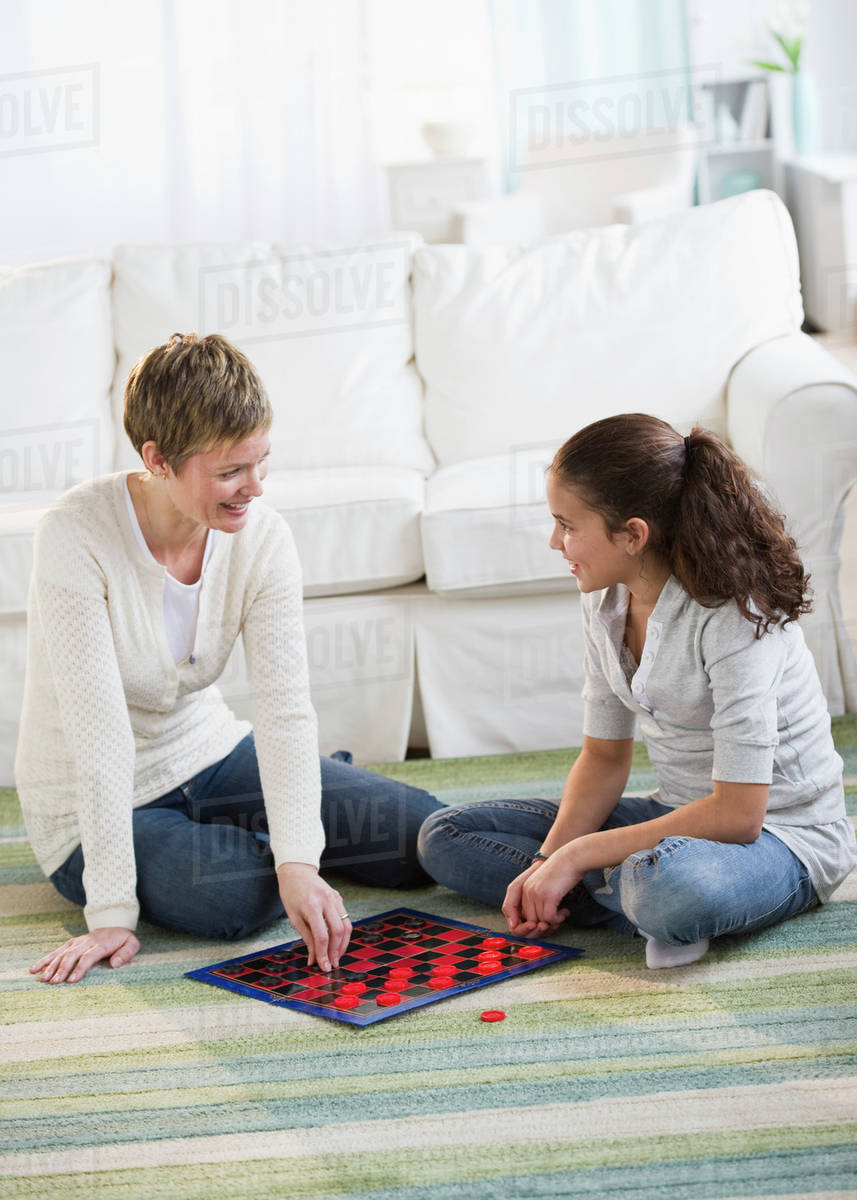 Mother and daughter playing checkers - Royalty-free Stock Photo | Dissolve