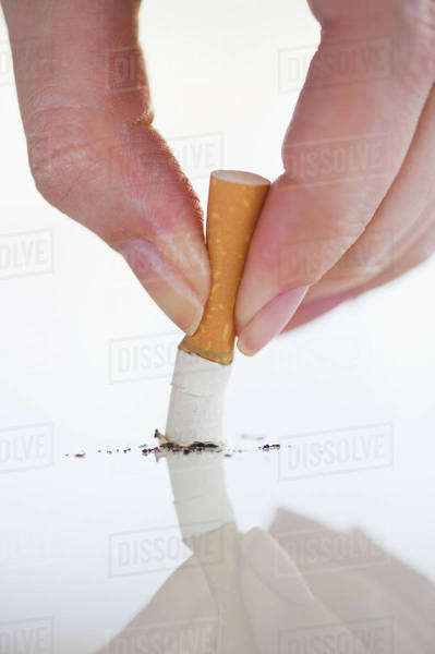 Hand putting out cigarette - Royalty-free Stock Photo | Dissolve