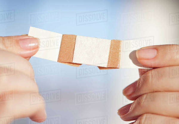 Hand holding band-aid - Royalty-free Stock Photo | Dissolve
