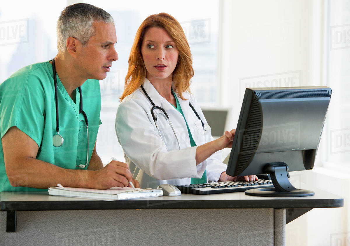 Healthcare professionals working at computer - Royalty-free Stock Photo ...