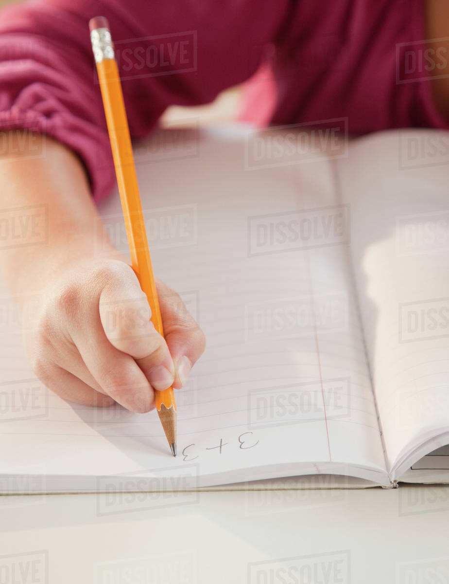 Young girl doing math homework - Stock Photo - Dissolve