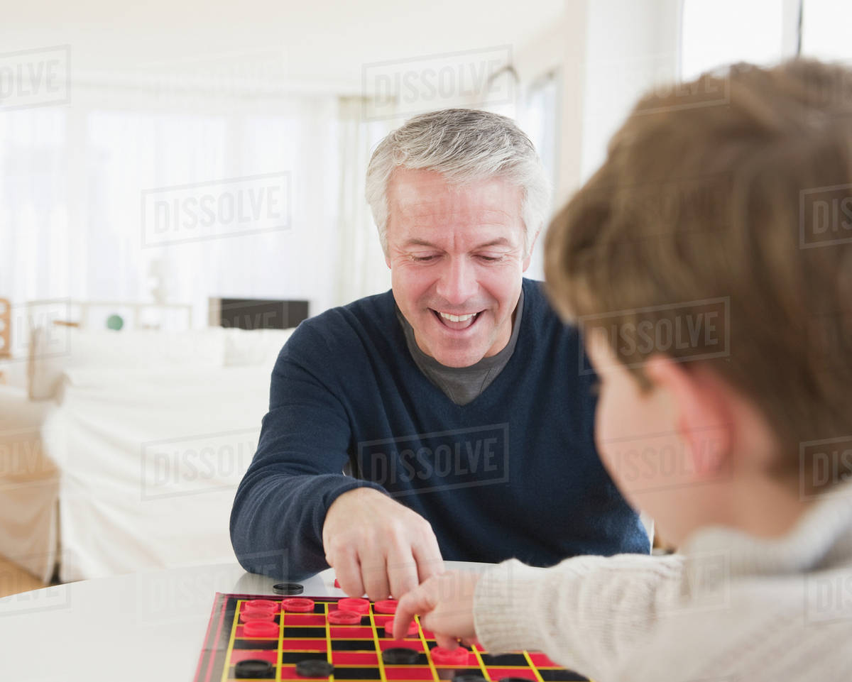 Father and son playing checkers - Royalty-free Stock Photo | Dissolve