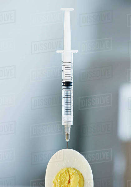 Syringe in a sliced egg - Royalty-free Stock Photo | Dissolve