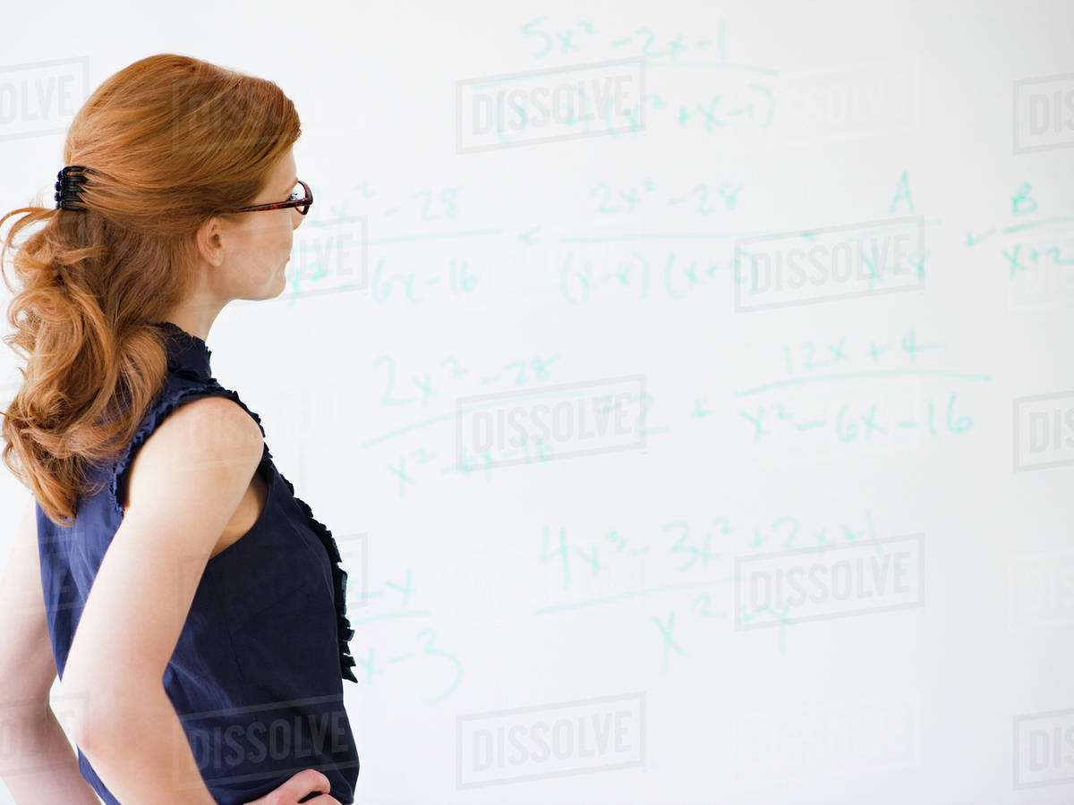 Woman doing math equations - Stock Photo - Dissolve