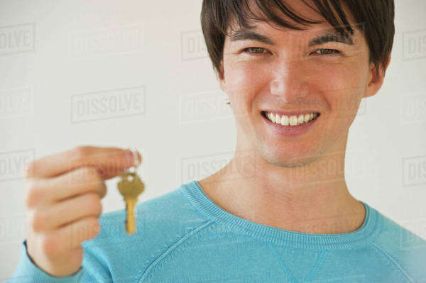 Man holding key - Royalty-free Stock Photo | Dissolve
