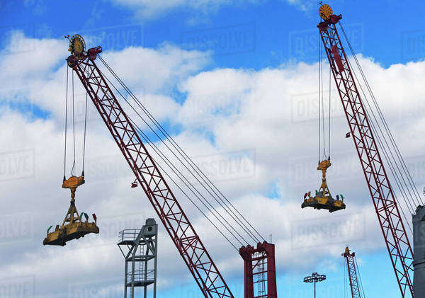 Cranes lifting cargo - Stock Photo - Dissolve