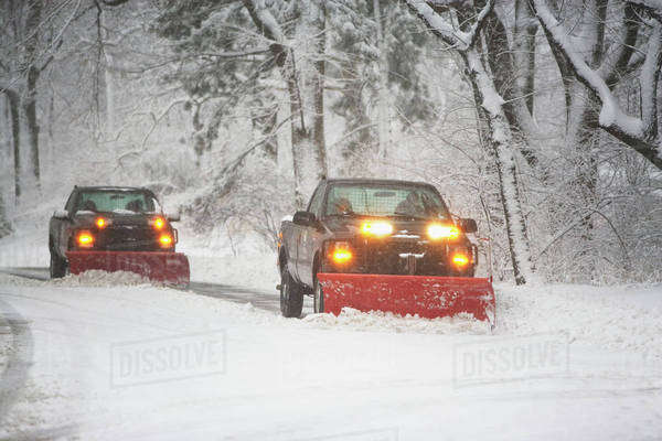 Trucks plowing snow off the road - Royalty-free Stock Photo | Dissolve