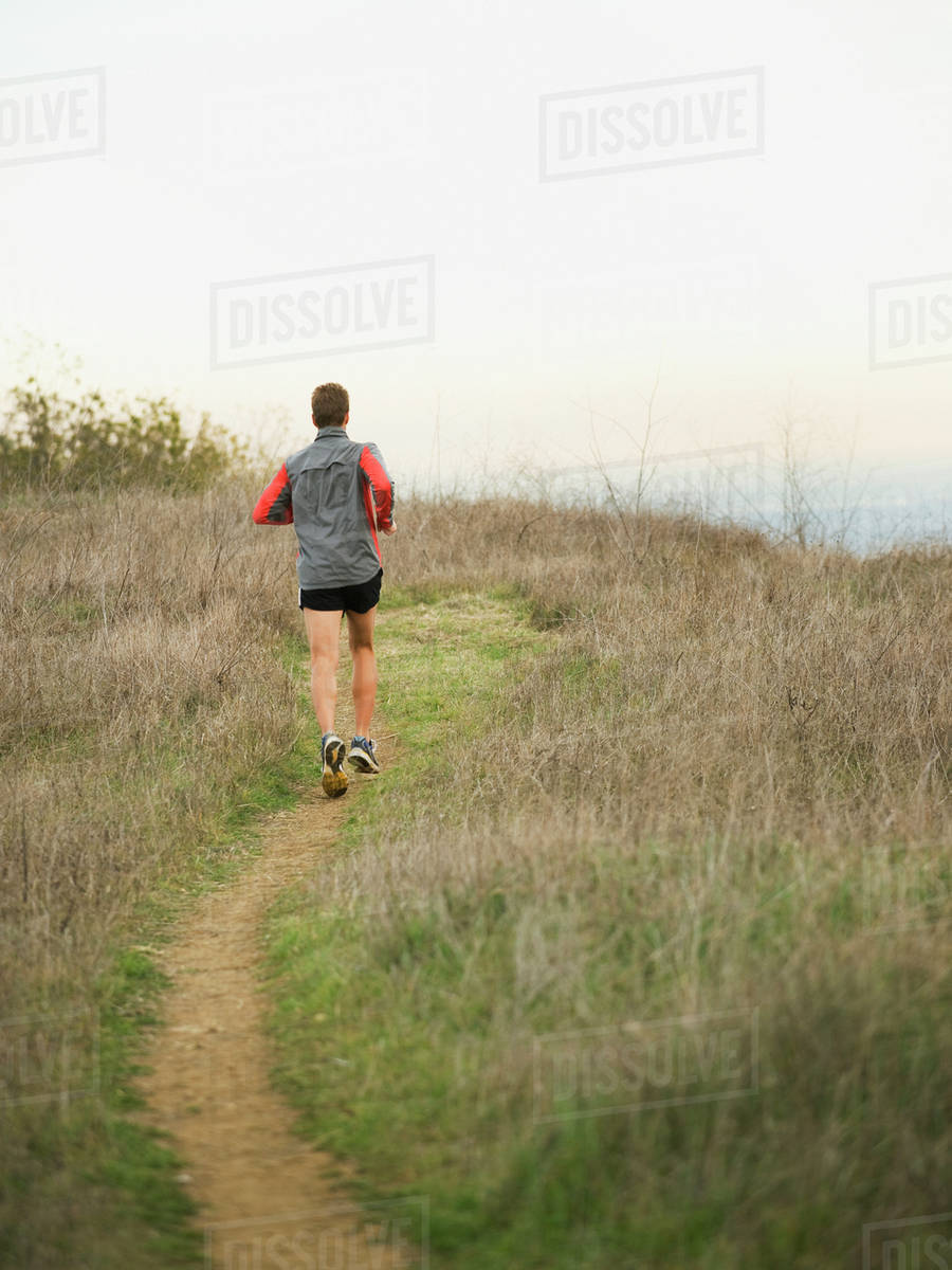 Person running on trail - Stock Photo - Dissolve