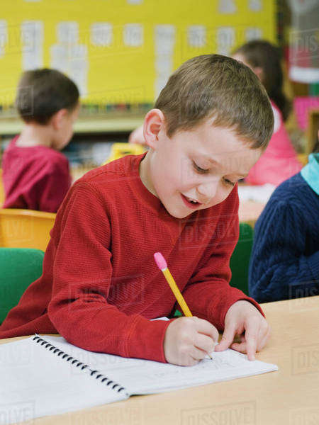 Kindergarten student writing in notebook - Royalty-free Stock Photo ...