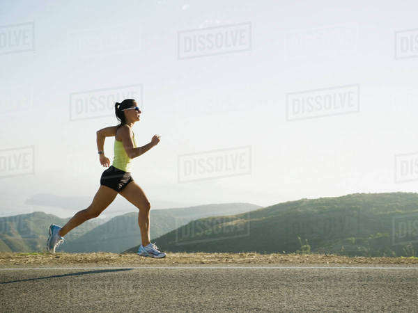 Runner training on the side of the road - Royalty-free Stock Photo ...