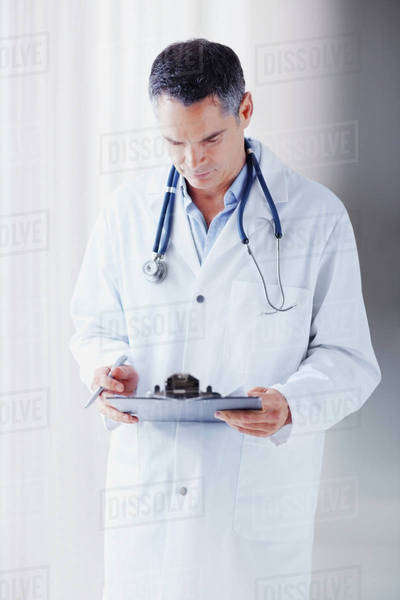 Doctor reading chart - Royalty-free Stock Photo | Dissolve