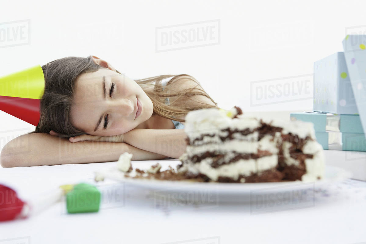 Tired young girl looking at birthday cake - Royalty-free Stock Photo ...