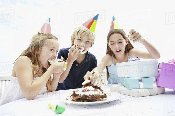 Children eating birthday cake - Royalty-free Stock Photo | Dissolve