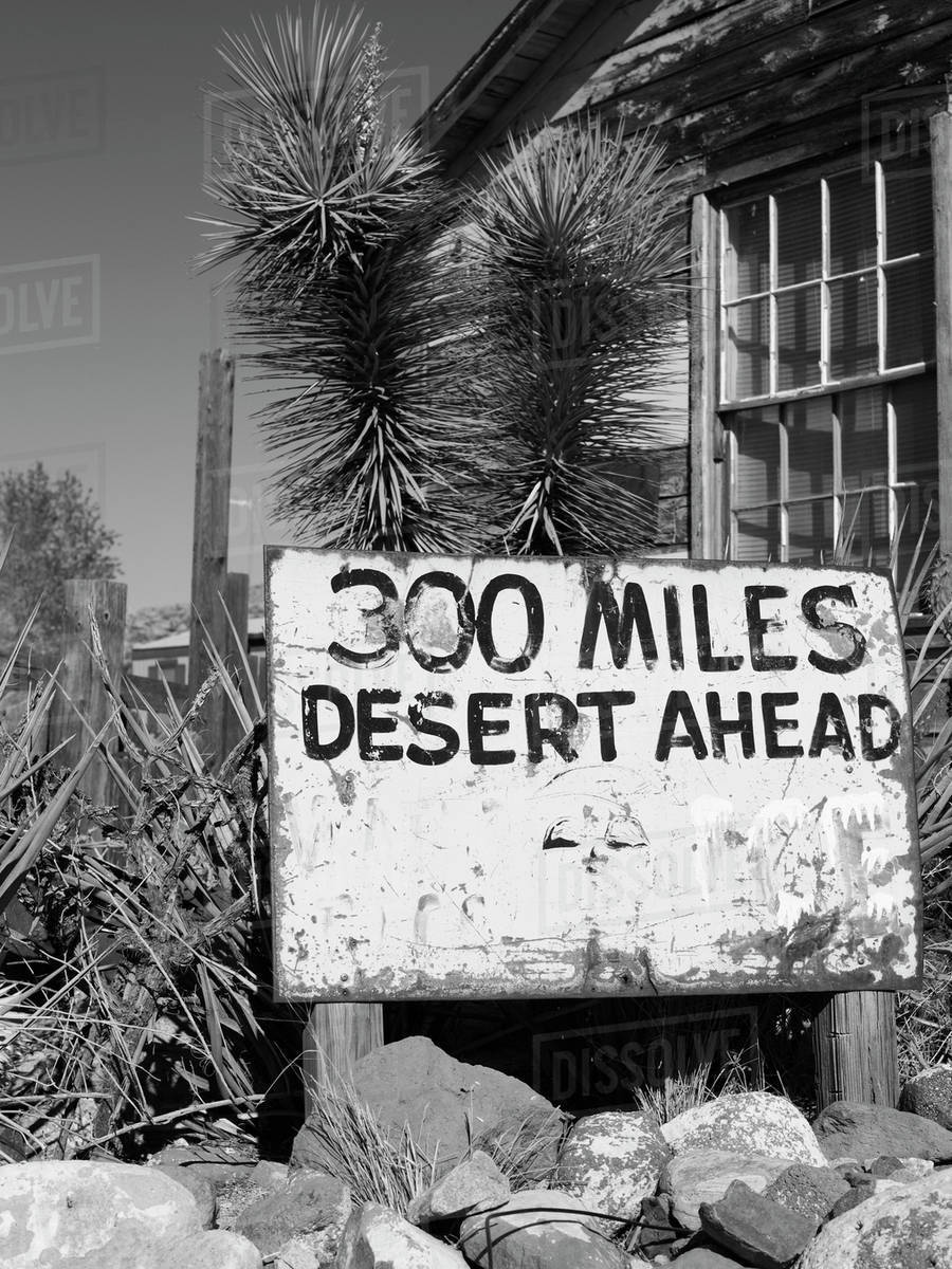 Road sign in the desert - Stock Photo - Dissolve