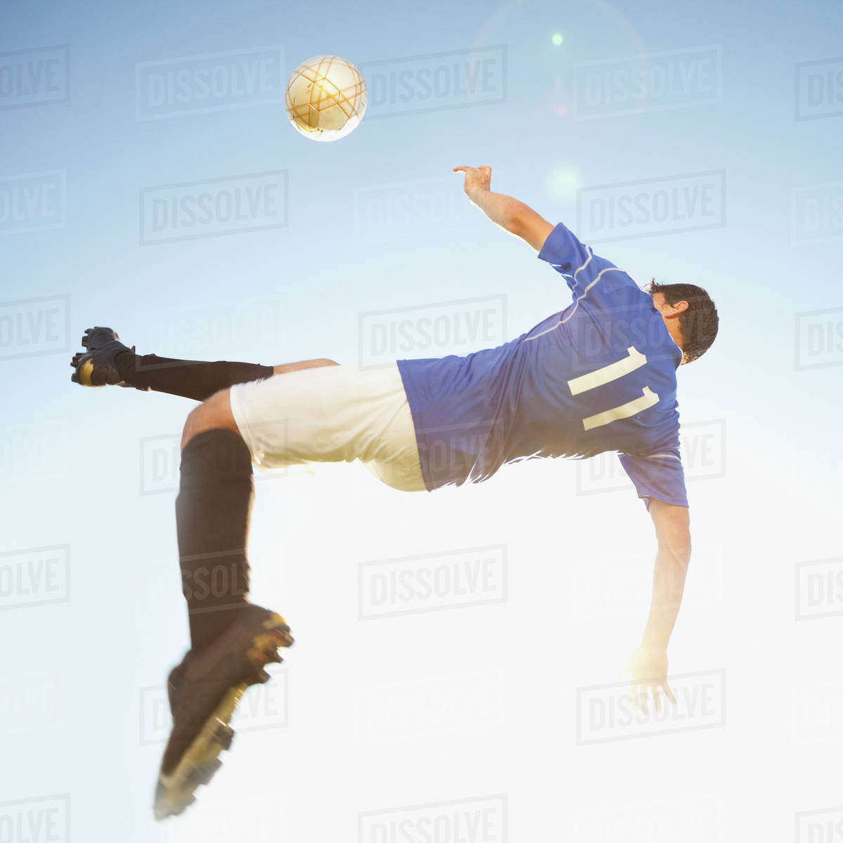 Soccer player jump kicking - Stock Photo - Dissolve