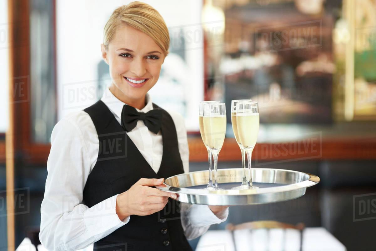 Portrait of waitress holding champagne flutes on tray - Royalty-free ...