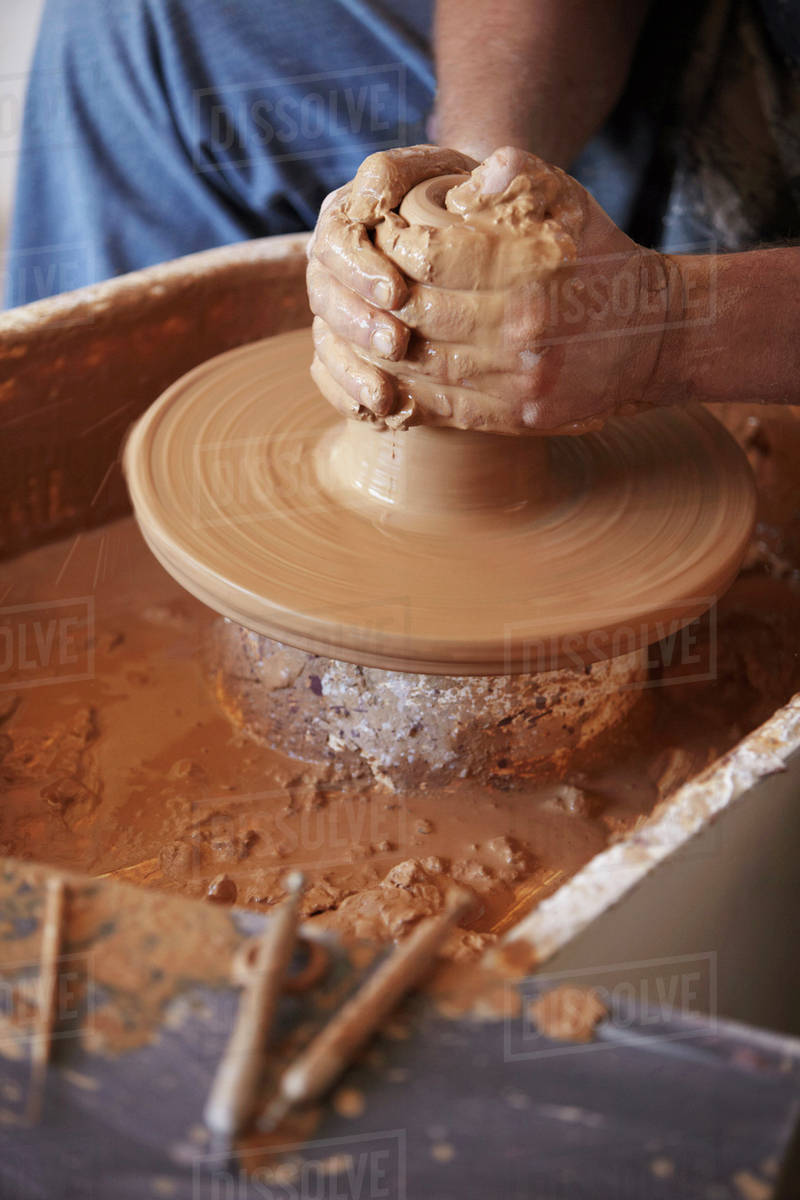 Hands working with clay on potter's wheel - Royalty-free Stock Photo ...