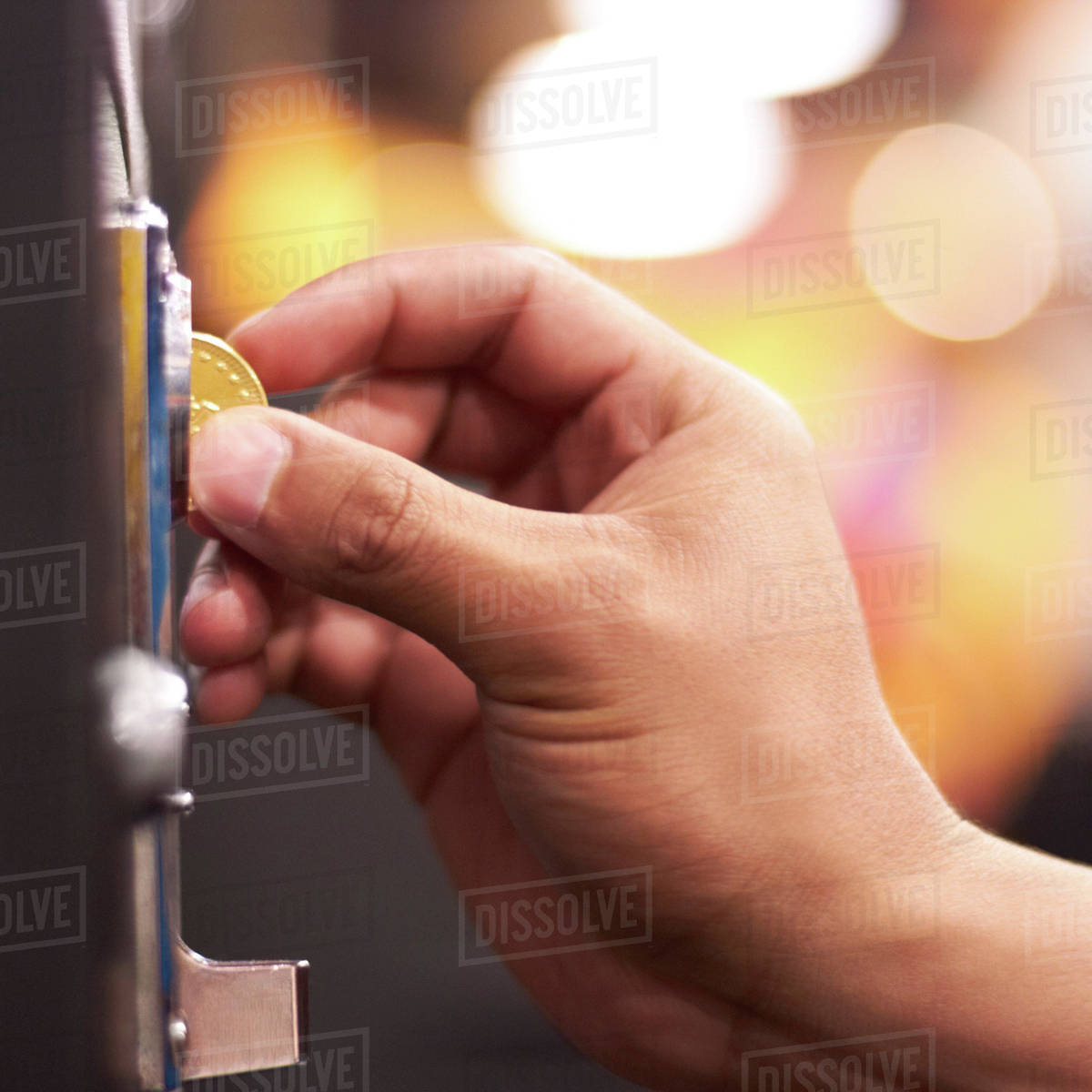 Hand inserting coin into machine - Royalty-free Stock Photo | Dissolve