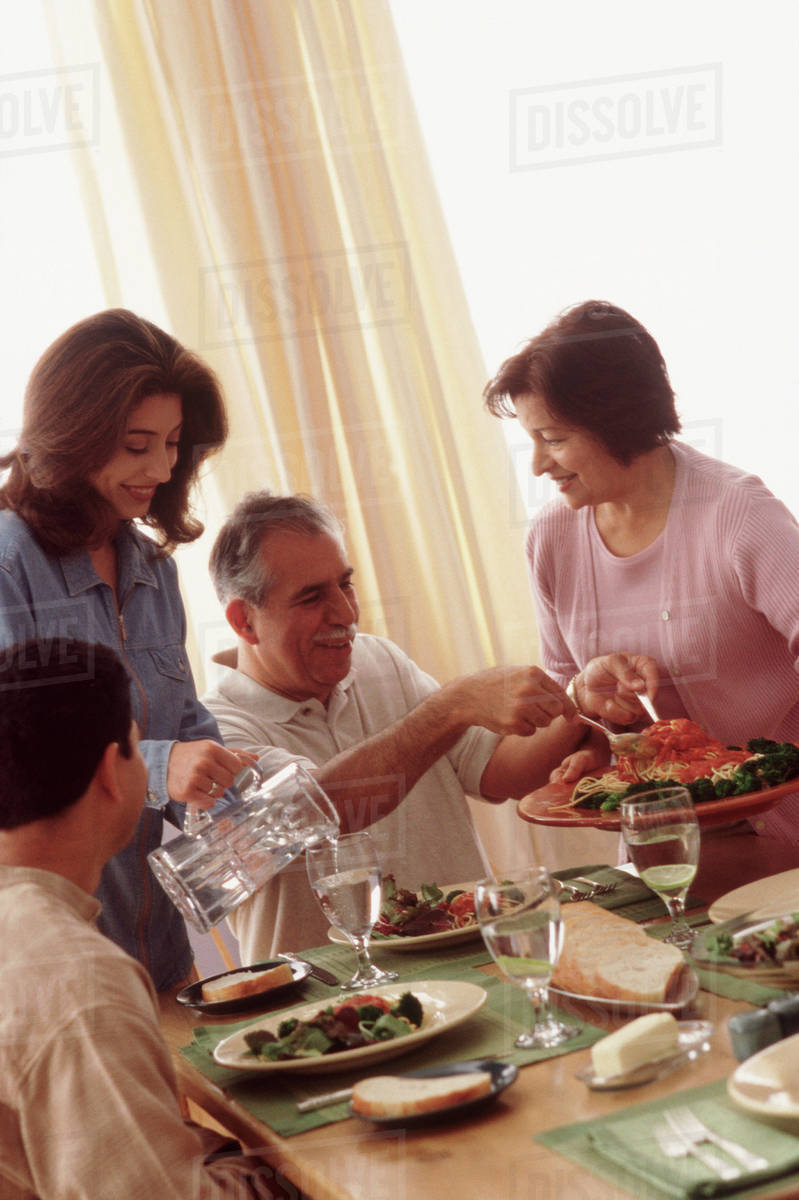 Family eating dinner together - Stock Photo - Dissolve