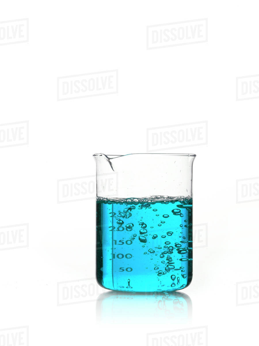 Blue liquid in measuring cup - Stock Photo - Dissolve