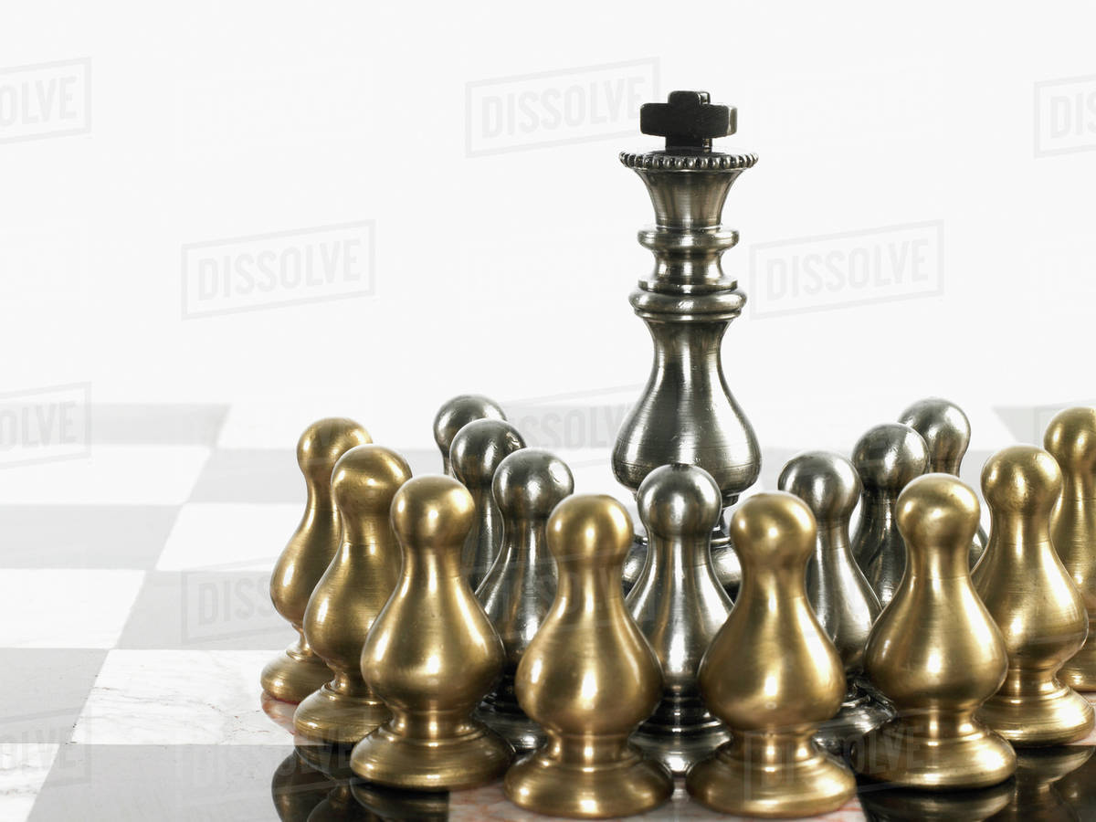 King surrounded by pawn chess pieces - Royalty-free Stock Photo | Dissolve