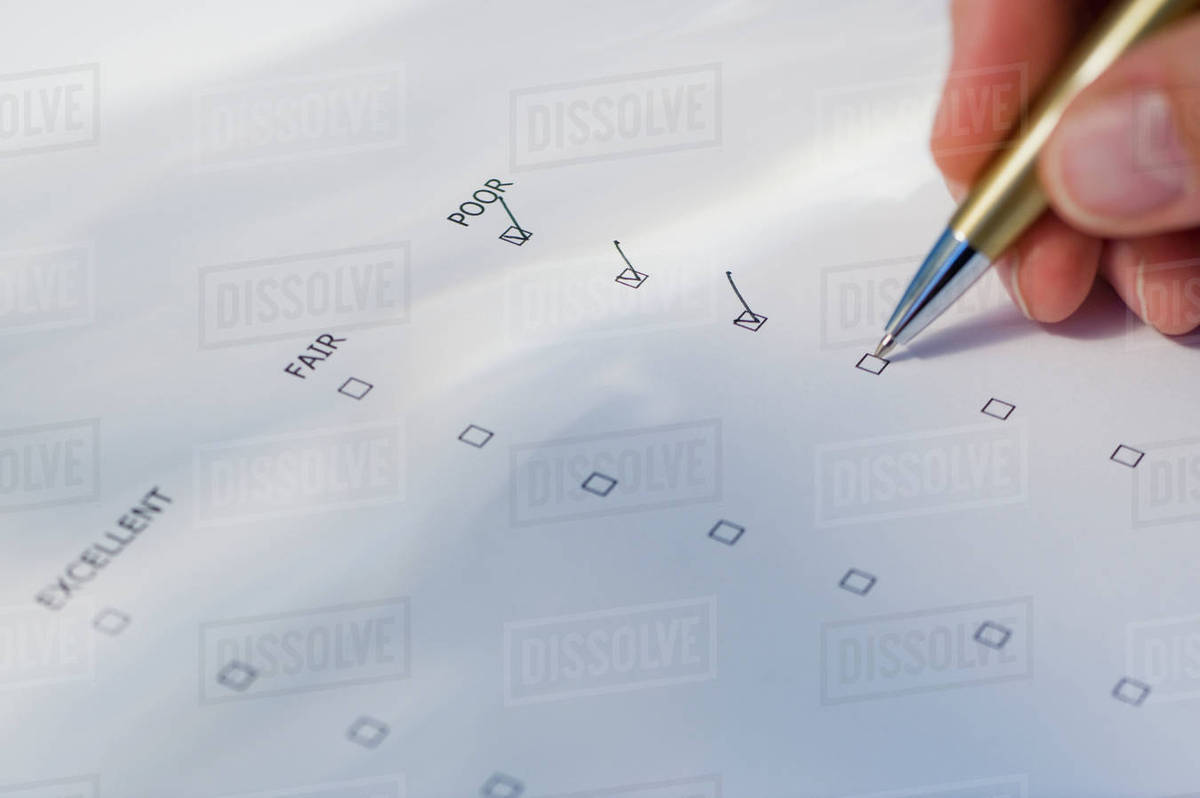 Man checking rating boxes - Stock Photo - Dissolve