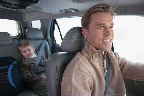 Father driving son to school - Stock Photo - Dissolve