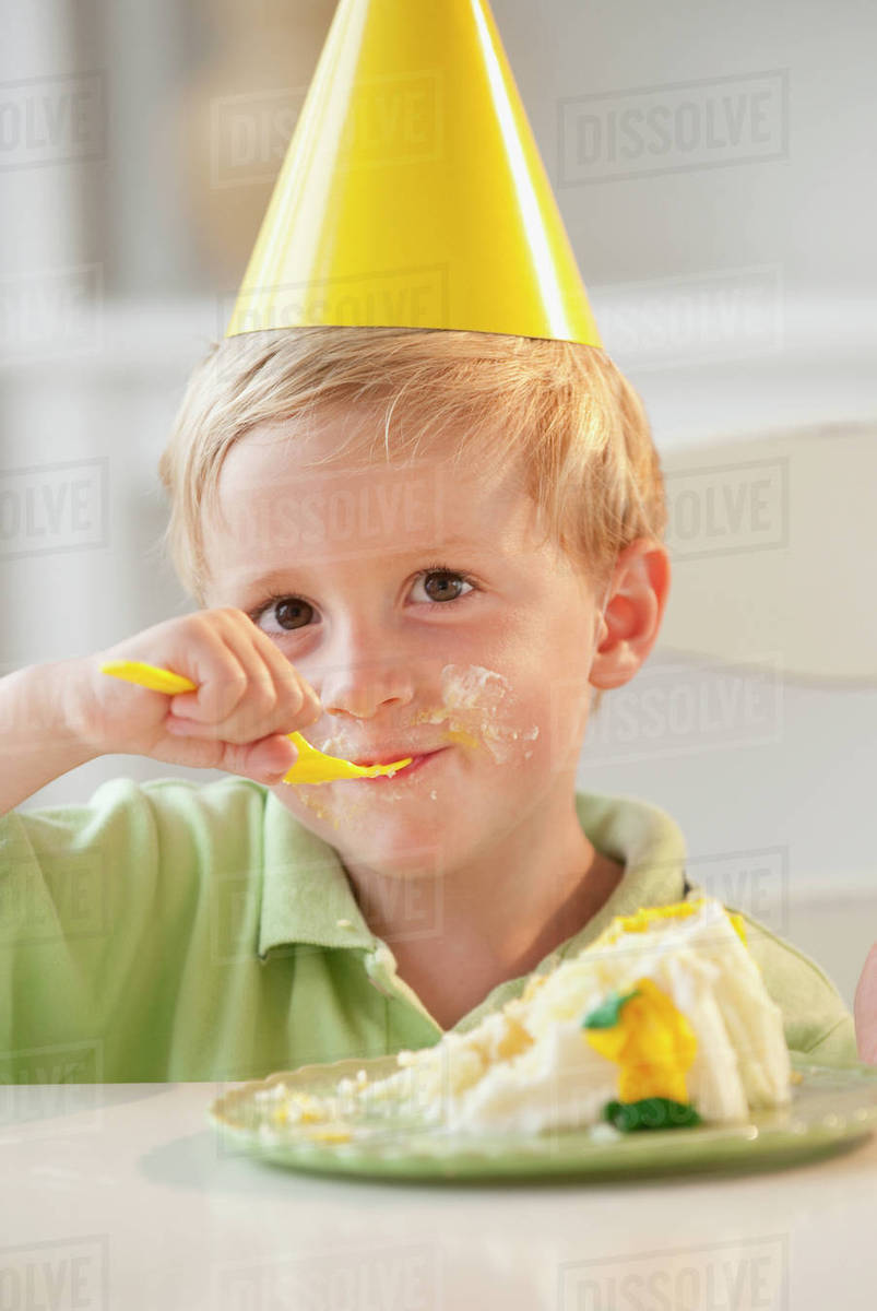 Young child eating birthday cake - Royalty-free Stock Photo | Dissolve