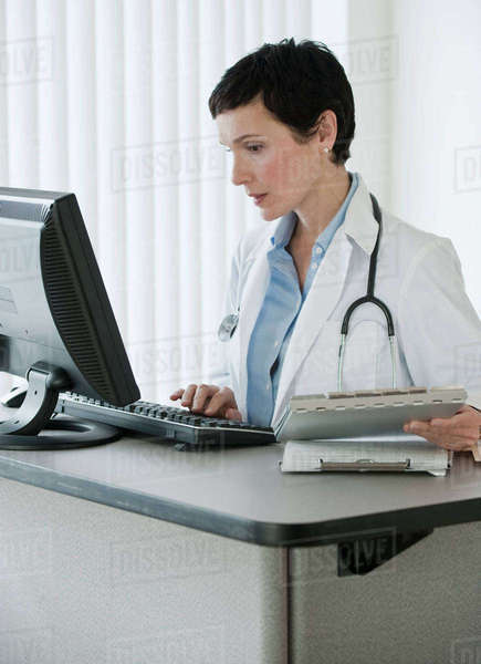 Doctor working on computer - Royalty-free Stock Photo | Dissolve