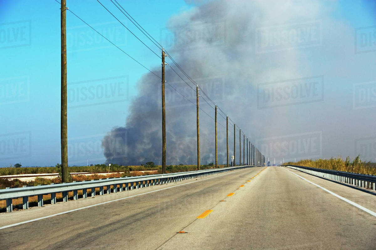 Highway and smoke in distance - Royalty-free Stock Photo | Dissolve