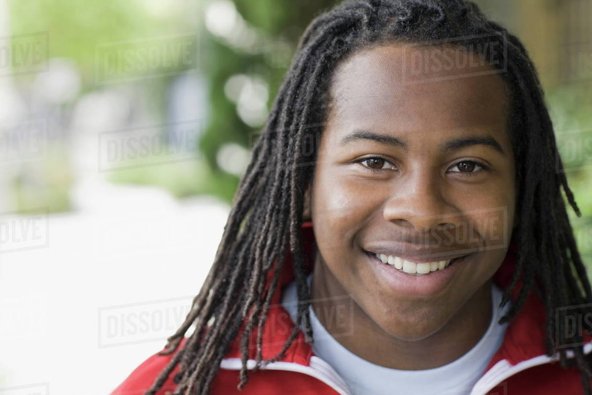 Portrait of teenage boy (16-17) with dreadlocks, smiling - Royalty-free ...