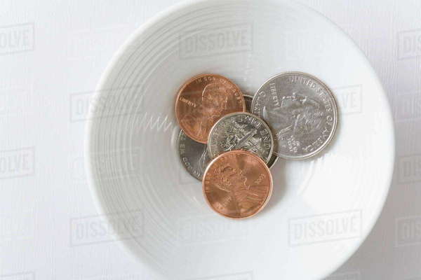 Coins in bowl - Stock Photo - Dissolve