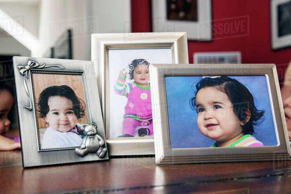 Children's (6-11 months) portraits in frames on table - Stock Photo ...