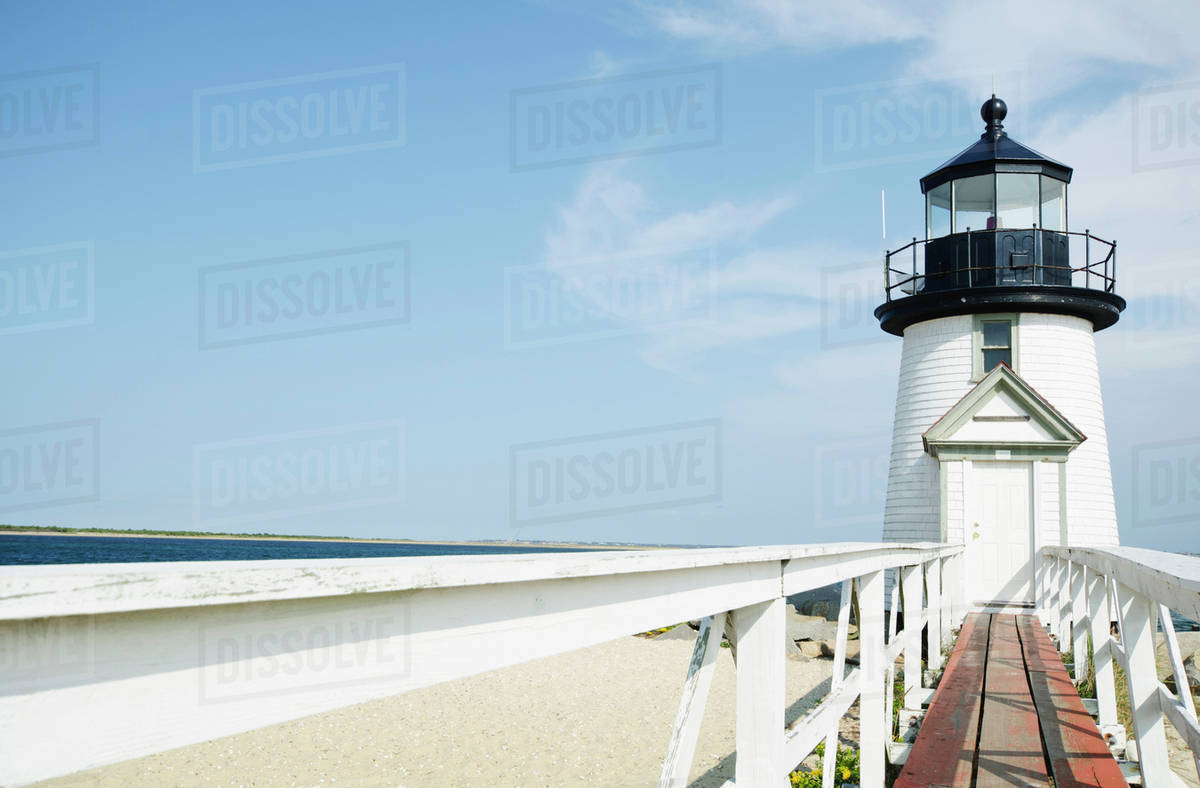 Lighthouse on sandy beach - Royalty-free Stock Photo | Dissolve