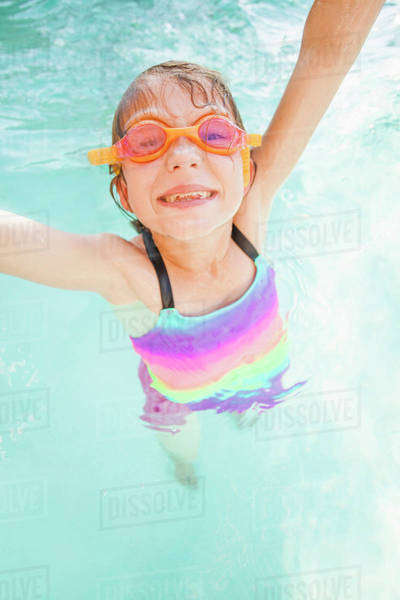 Girl (8-9) playing in swimming pool - Royalty-free Stock Photo | Dissolve