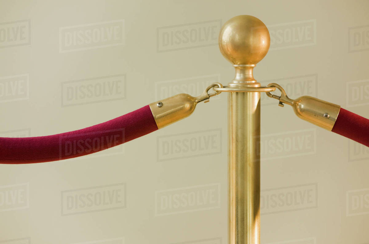 Close up of velvet rope and stanchion - Royalty-free Stock Photo | Dissolve