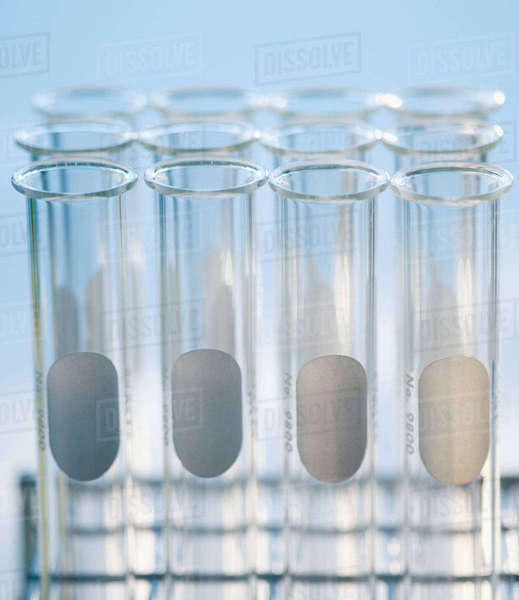 Close up of empty vials in tray - Royalty-free Stock Photo | Dissolve