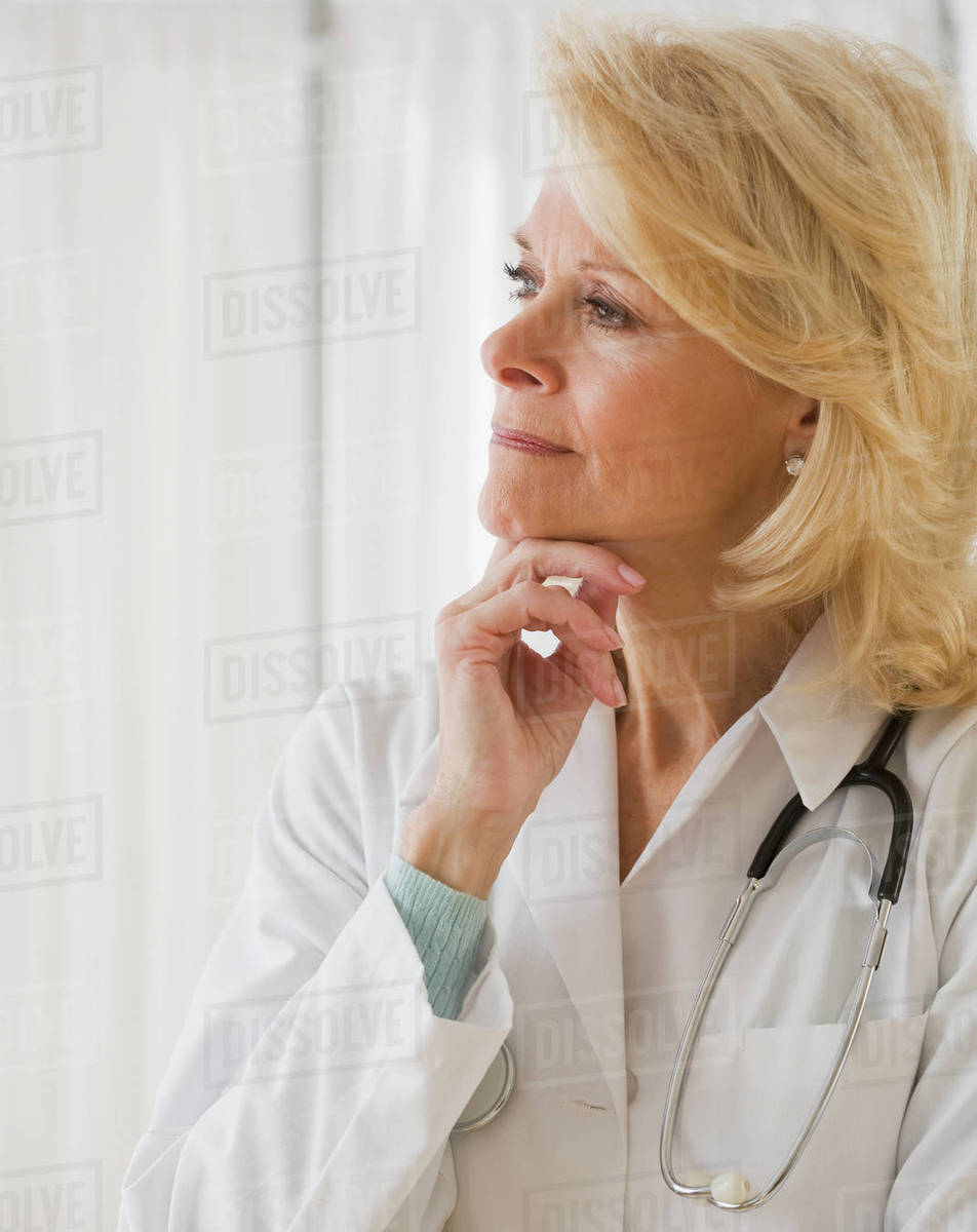 Female doctor thinking - Stock Photo - Dissolve