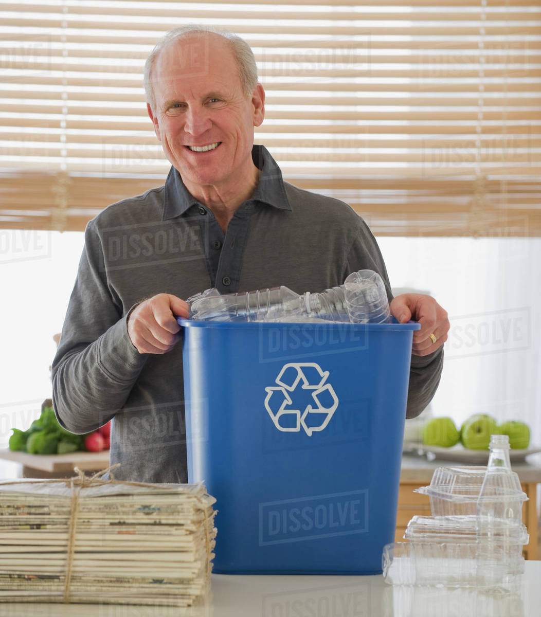Senior man holding recycling bin - Royalty-free Stock Photo | Dissolve