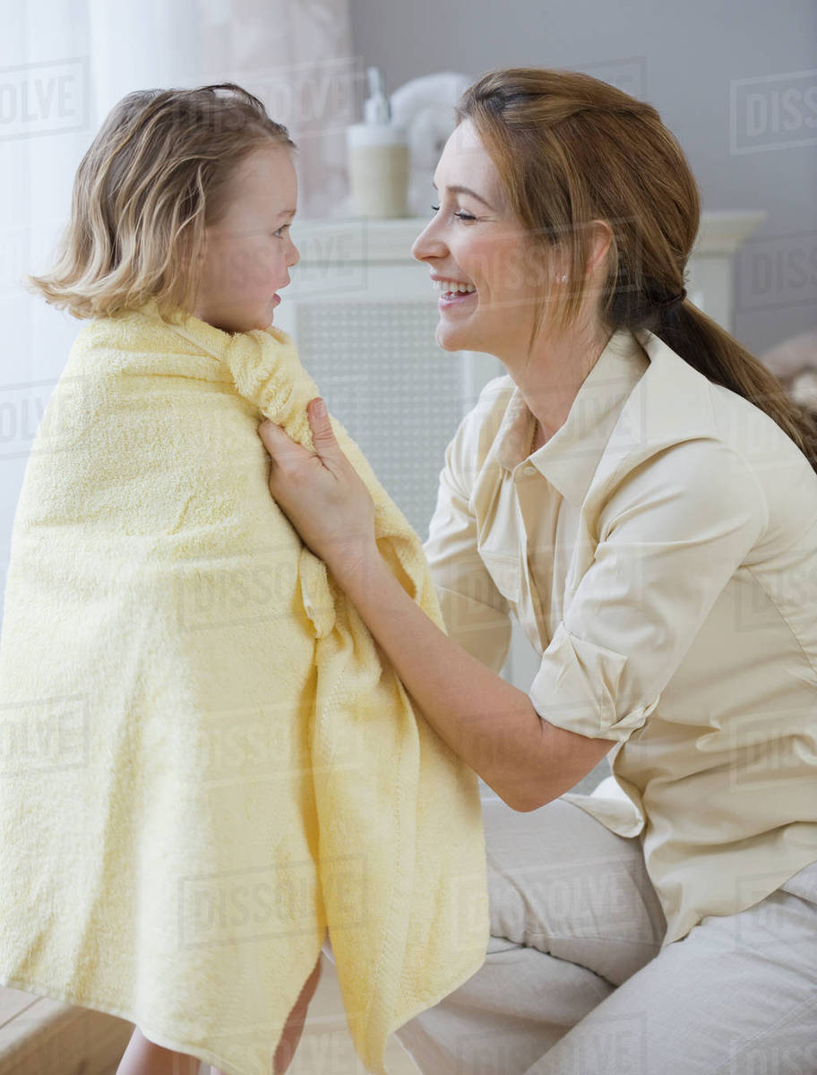 Mother drying daughter with towel - Royalty-free Stock Photo | Dissolve