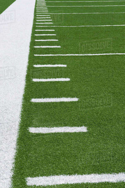 Yard line markers on football field - Stock Photo - Dissolve