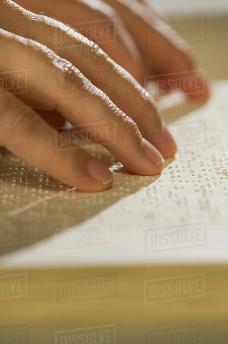 Close up of hand reading braille - Stock Photo - Dissolve