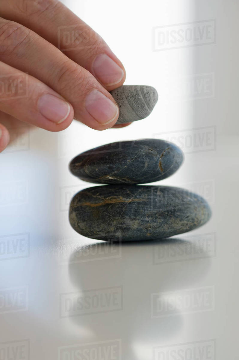 Hand stacking stones - Royalty-free Stock Photo | Dissolve