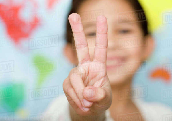 Child making peace sign hand gesture - Royalty-free Stock Photo | Dissolve